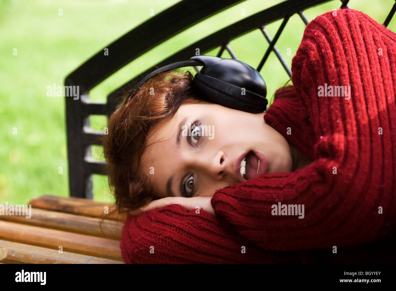 Scared young woman listening to music Stock Photo - Alamy