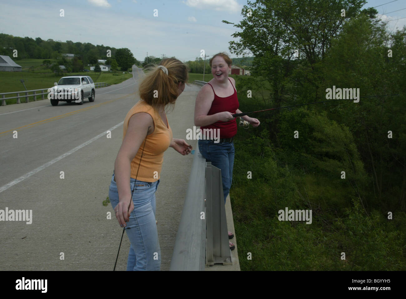 Shauna Marie Sanders, right, reacts after a large bass surfaced on her ...