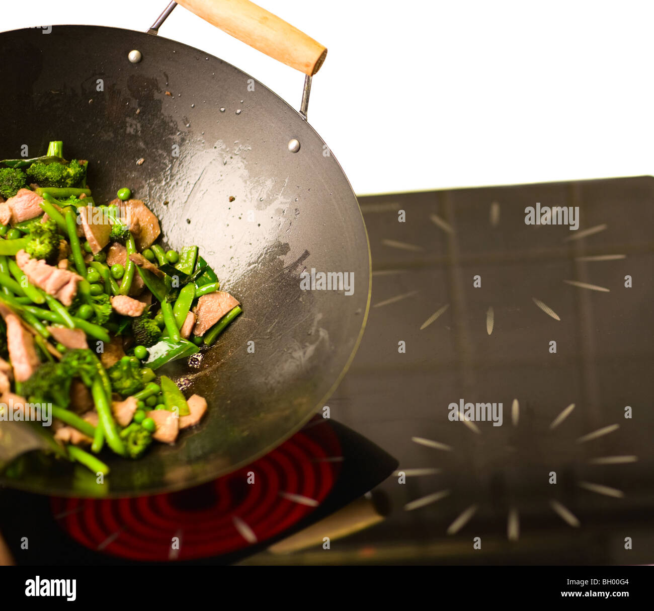 Chef cooking vegetables in wok pan Stock Photo - Alamy