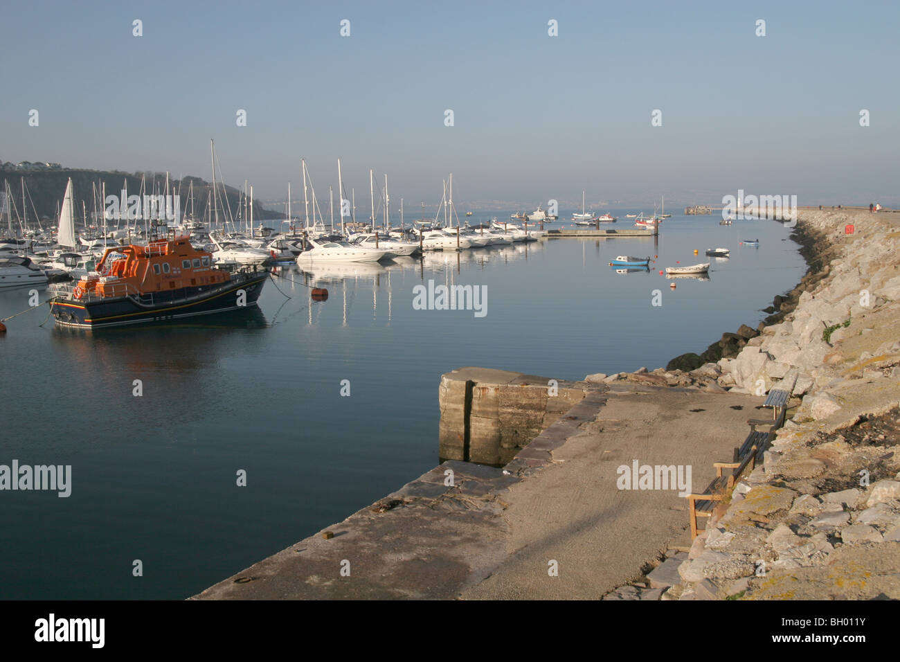 The breakwater and harbour at Brixham, Devon, with the lifeboat on the ...