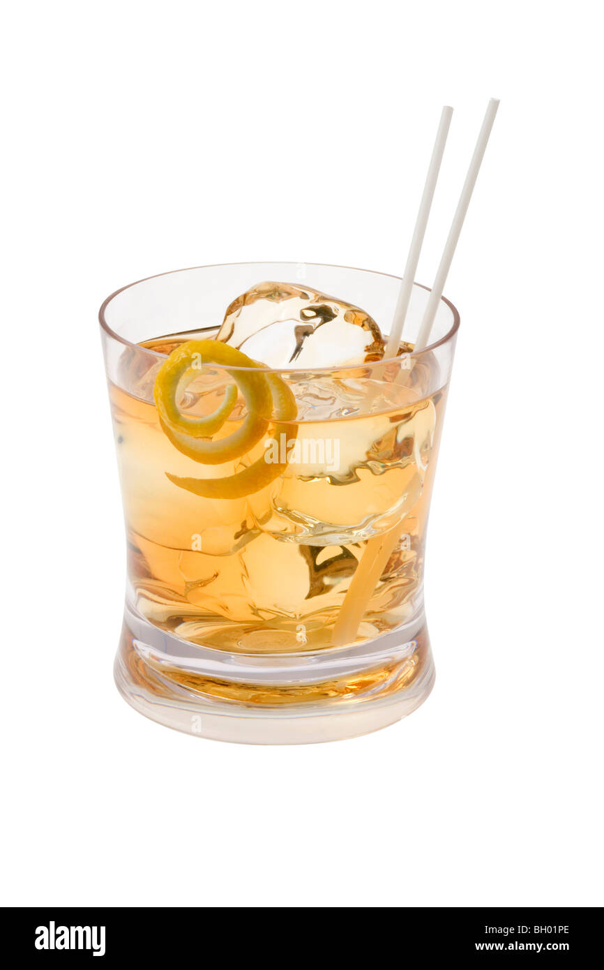 Scotch and water on the rocks with lemon peel garnish on white ...