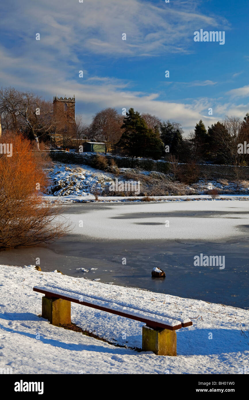 Duddingston Loch with snow covered winter scene empty bench Edinburgh ...