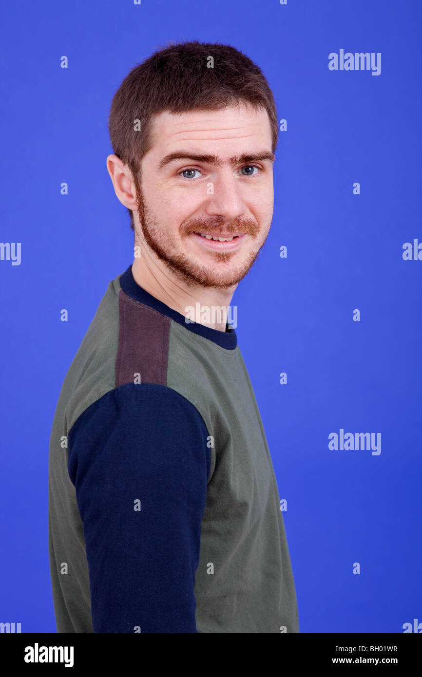 an young man portrait over a blue background Stock Photo - Alamy