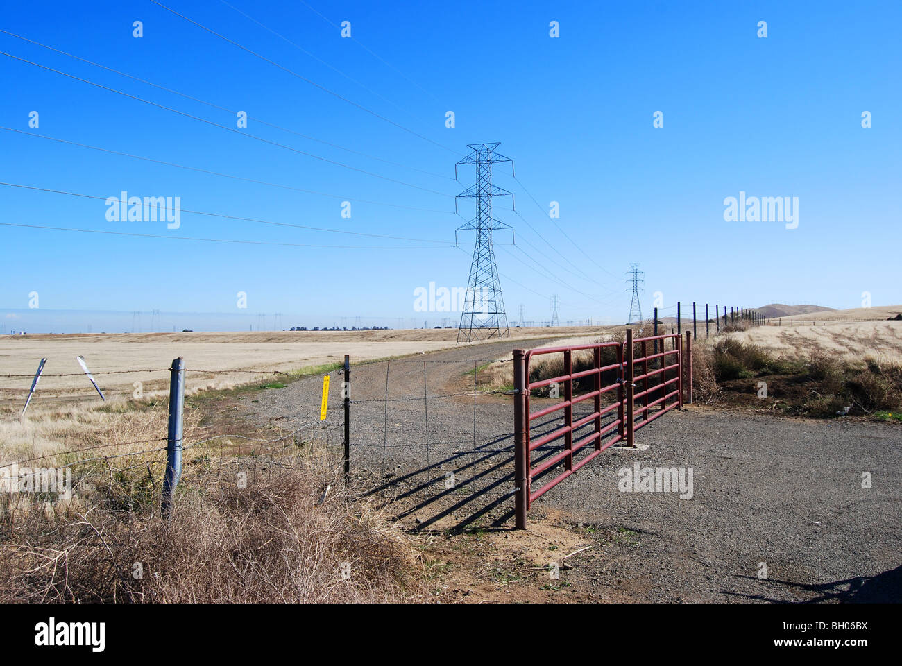 gated power line road in central califorina Stock Photo - Alamy