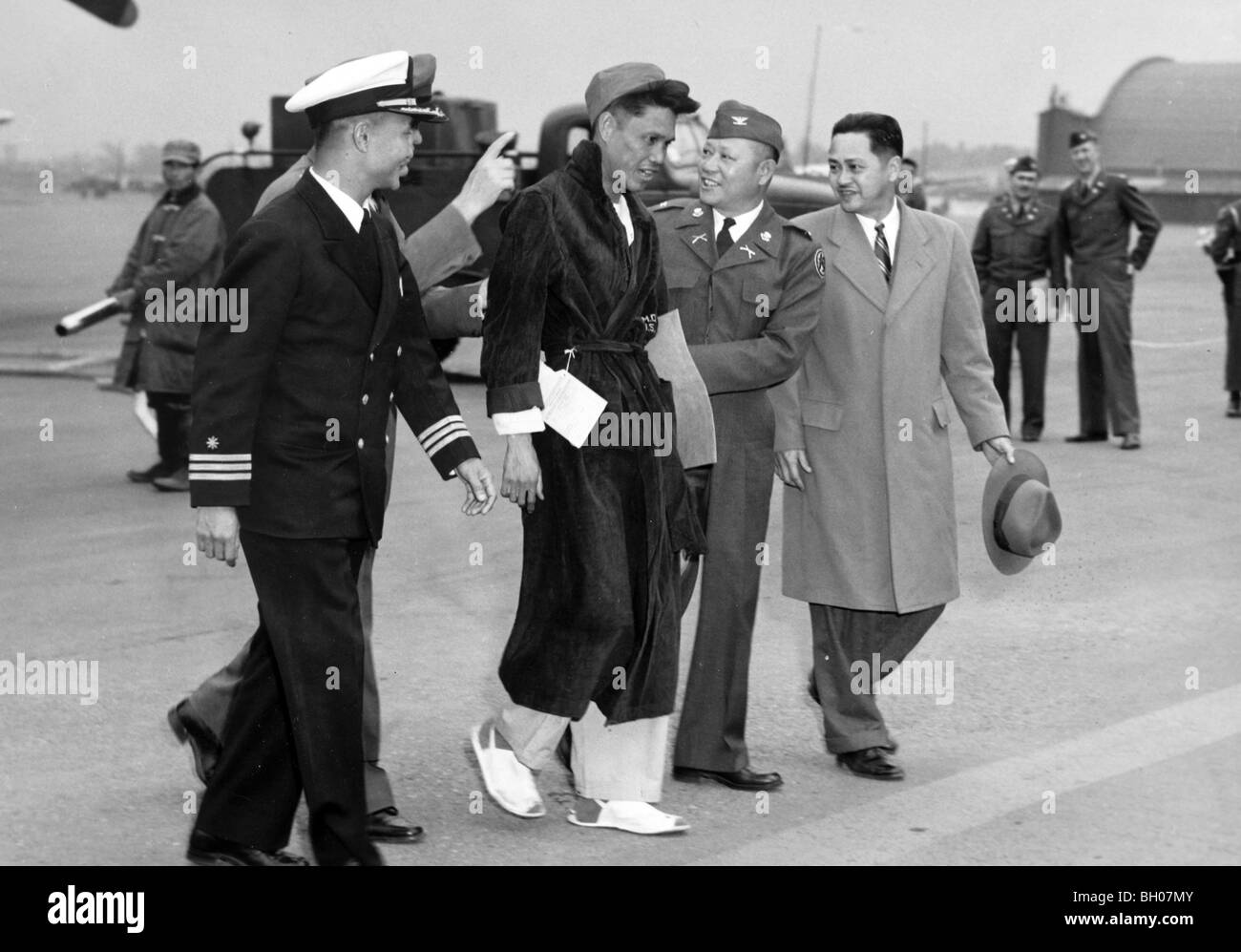 HQ. FEAF, TOKYO --- Sgt. Juanito Magno of Iloilo City, P.I., receives a ...