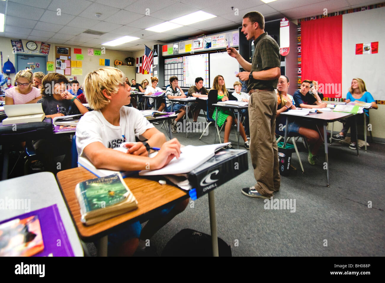 An enthusiastic middle school Spanish teacher conducts his eight-grade ...