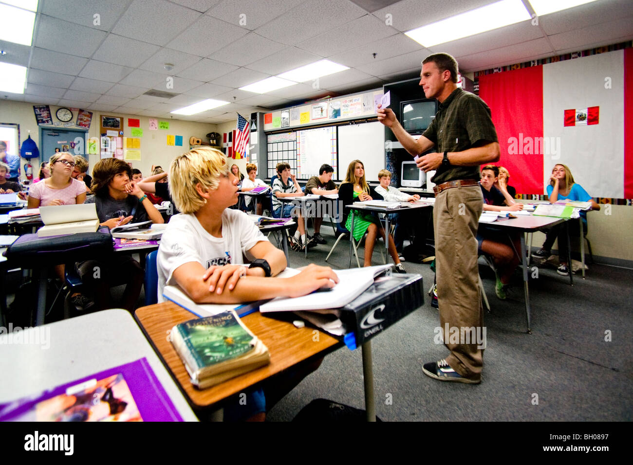 An enthusiastic middle school Spanish teacher conducts his eight-grade ...