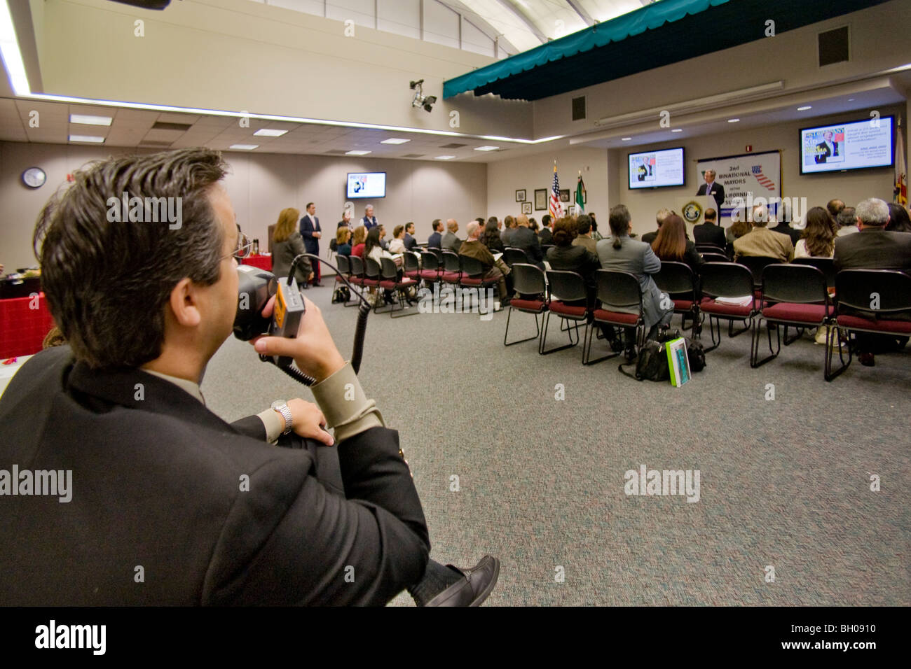 Using a microphone and cordless transmitter, a Hispanic simultaneous ...