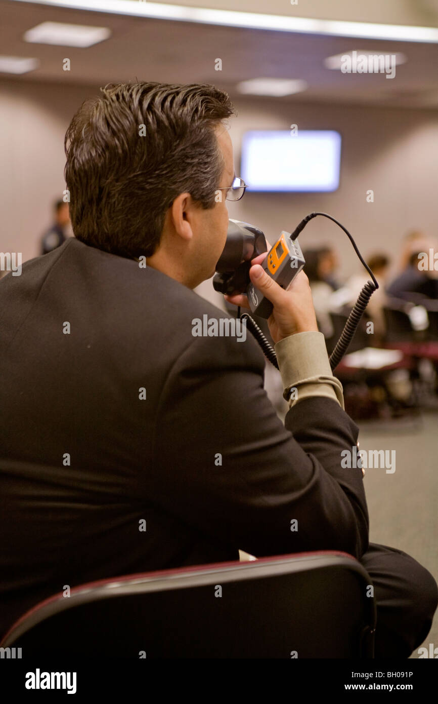 Using a microphone and cordless transmitter, a Hispanic simultaneous ...