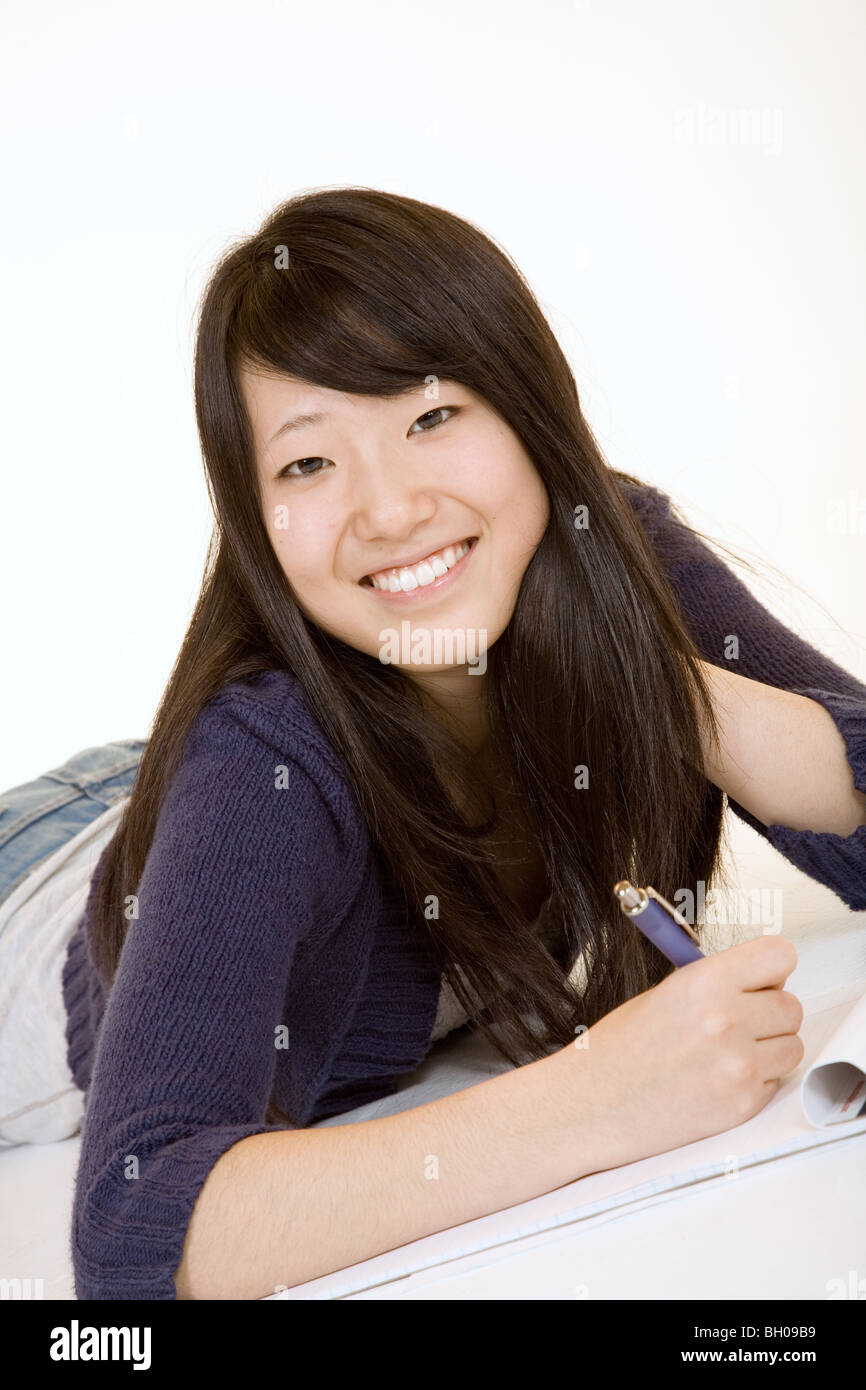 Asian teenage working on homework hi-res stock photography and images ...