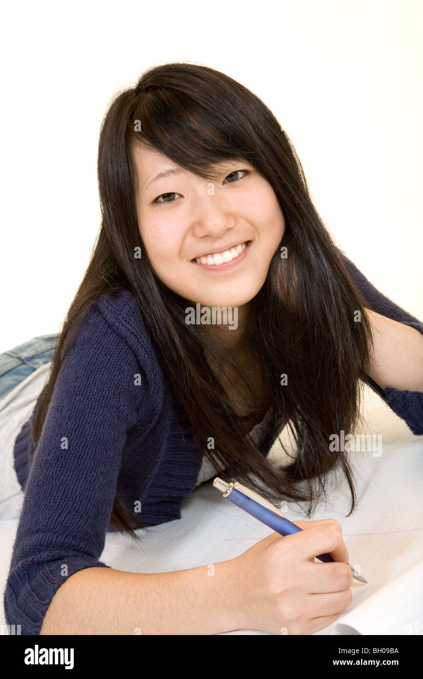 Asian teenage working on homework hi-res stock photography and images ...