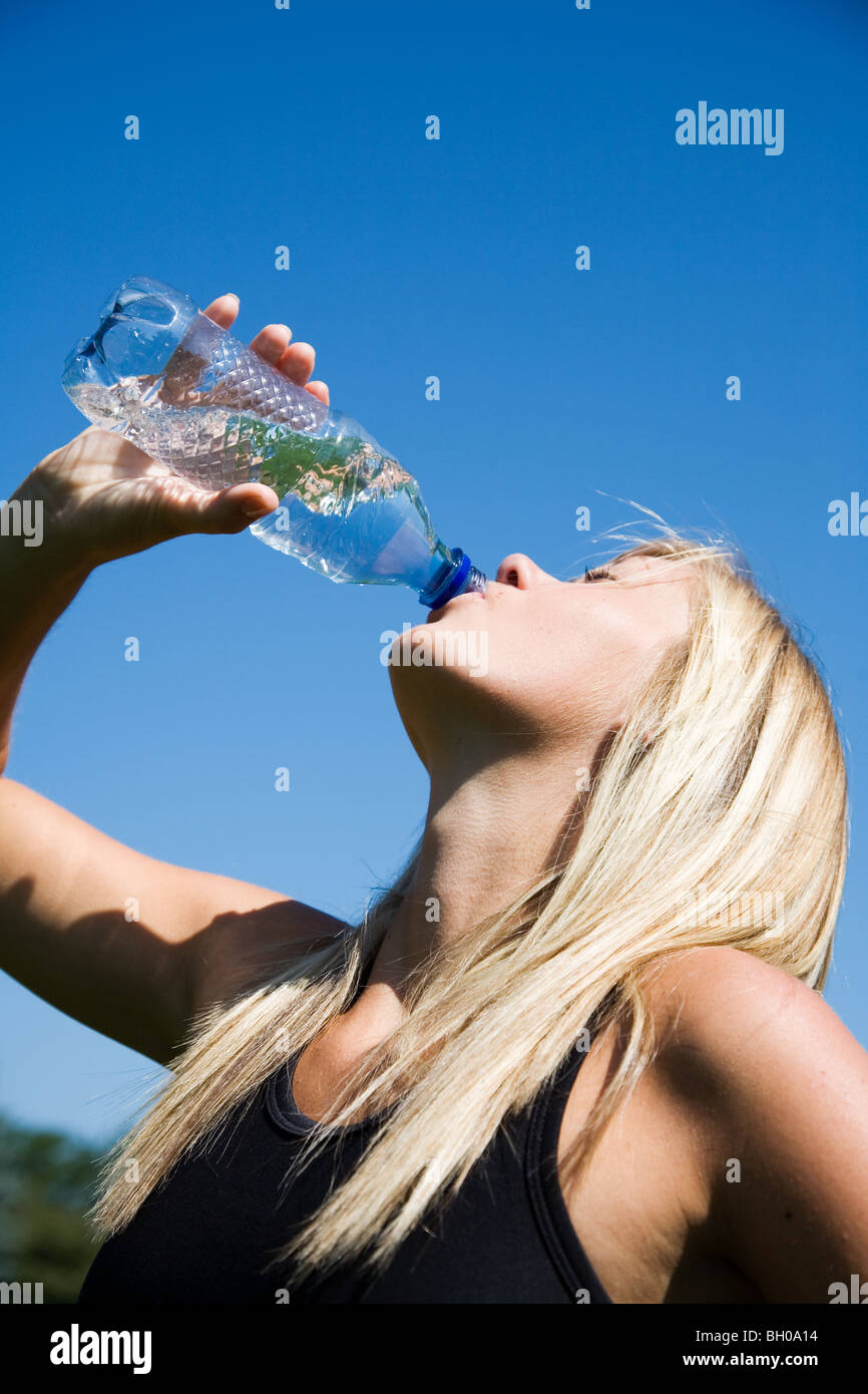 Teenage girl drinking water Stock Photo - Alamy