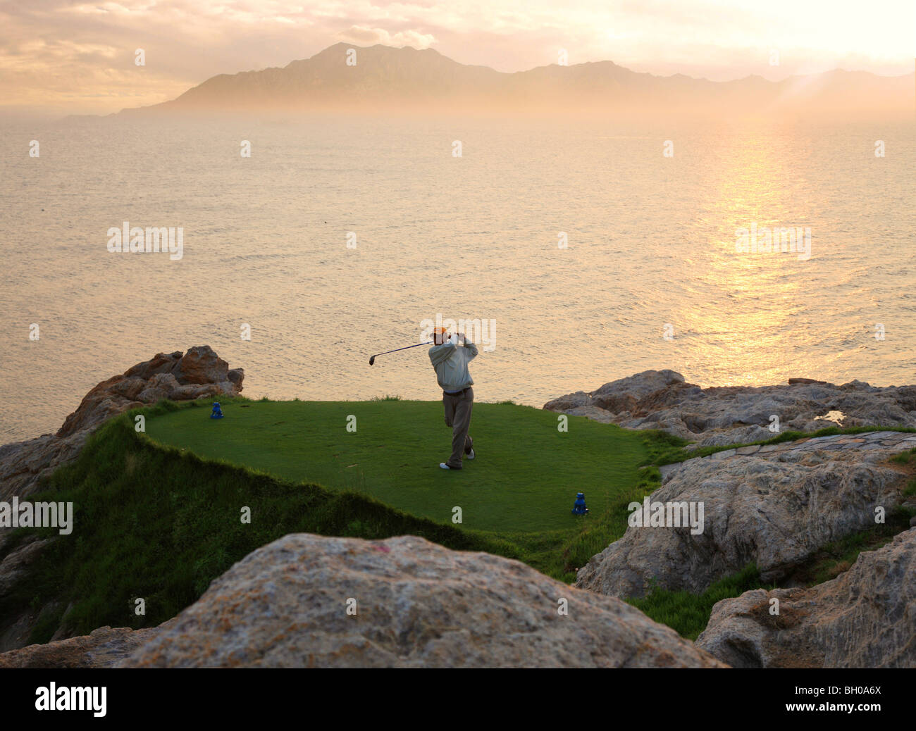 Man playing golf in golf course Stock Photo - Alamy