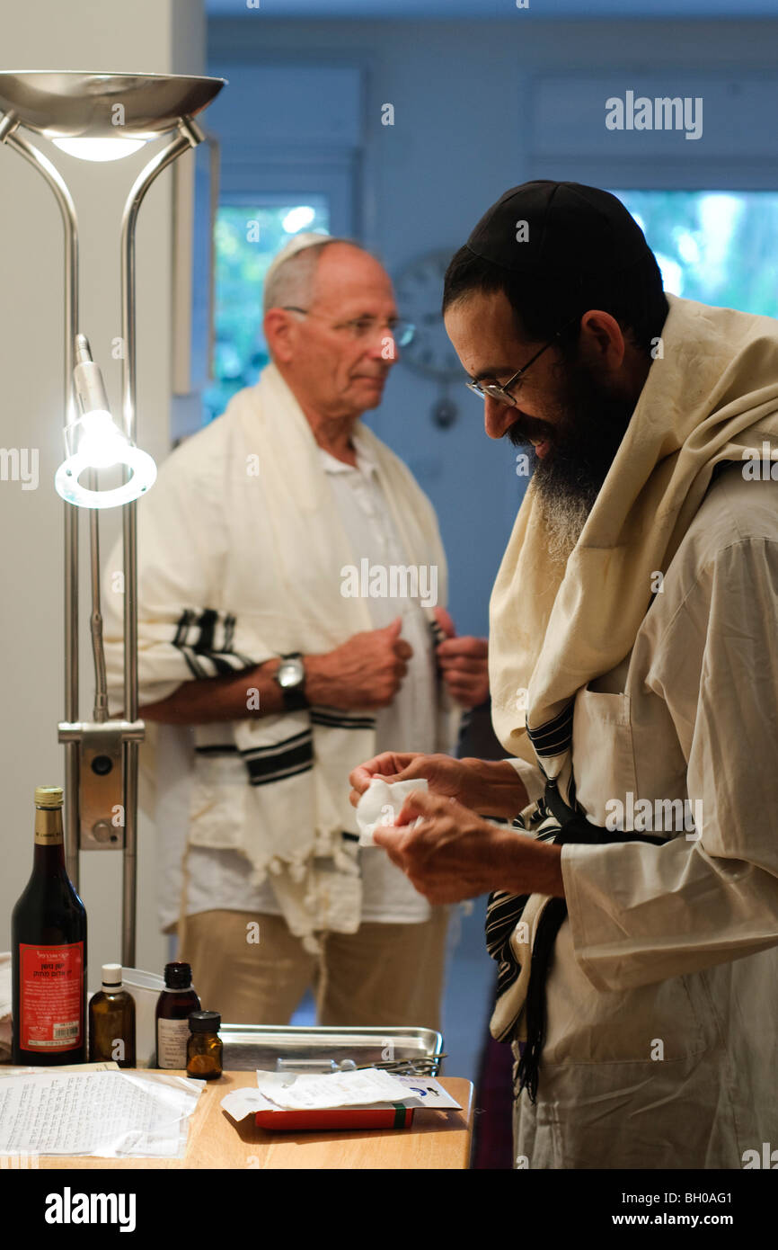 Circumcision - Brit Mila Ceremony The Mohel performs the rite Stock ...