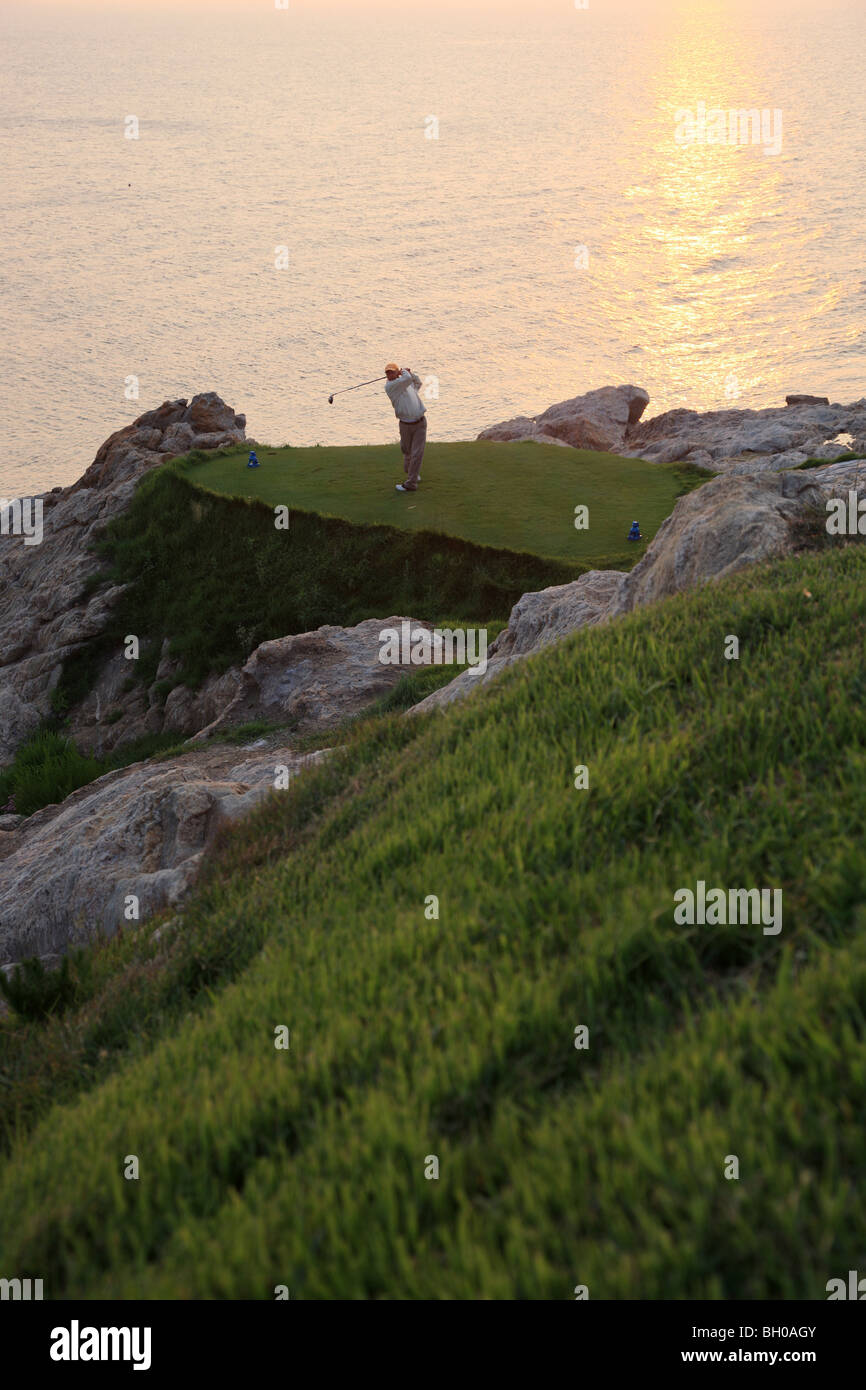 Man playing golf in golf course Stock Photo - Alamy