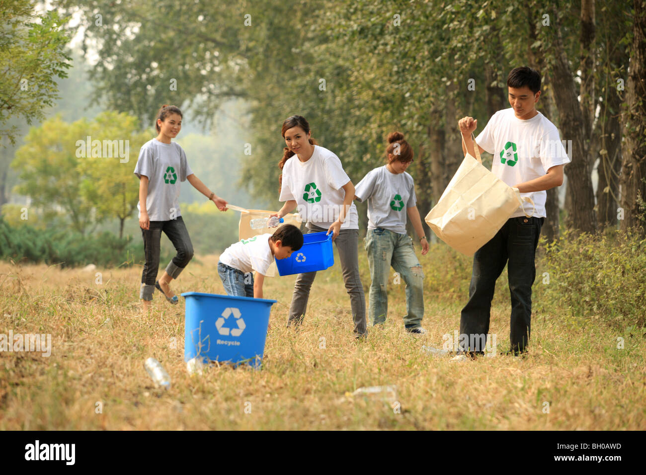 young people collecting empty plastic bottles for recycling Stock Photo ...