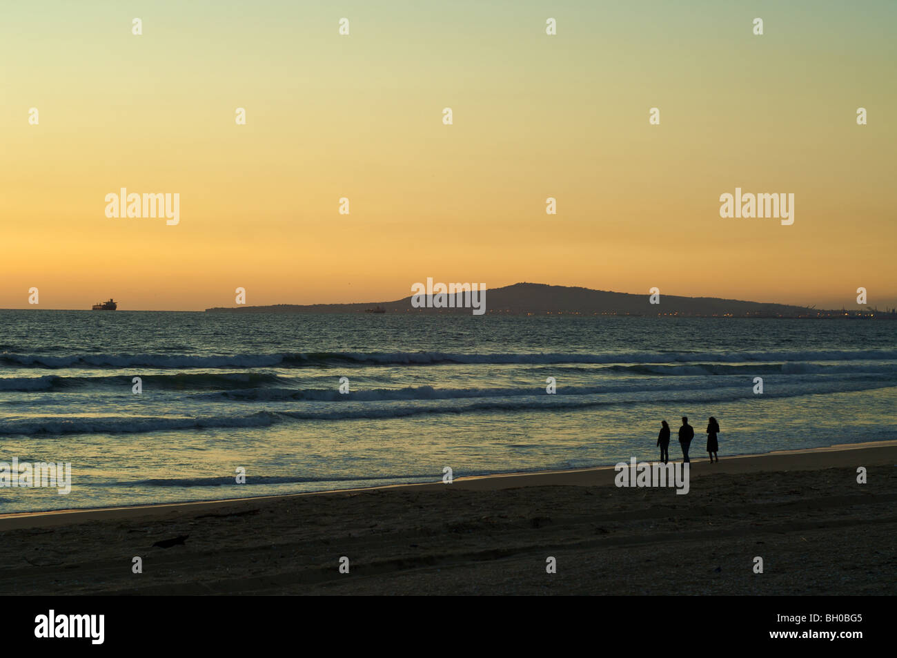 Three people at huntington beach Stock Photo - Alamy