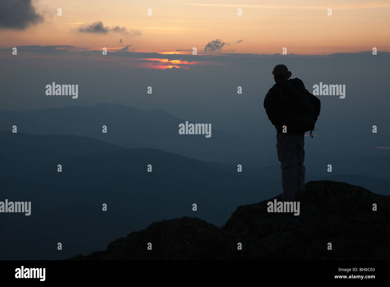 A hiker enjoys the sunset from Mount Clay. Located in the White ...