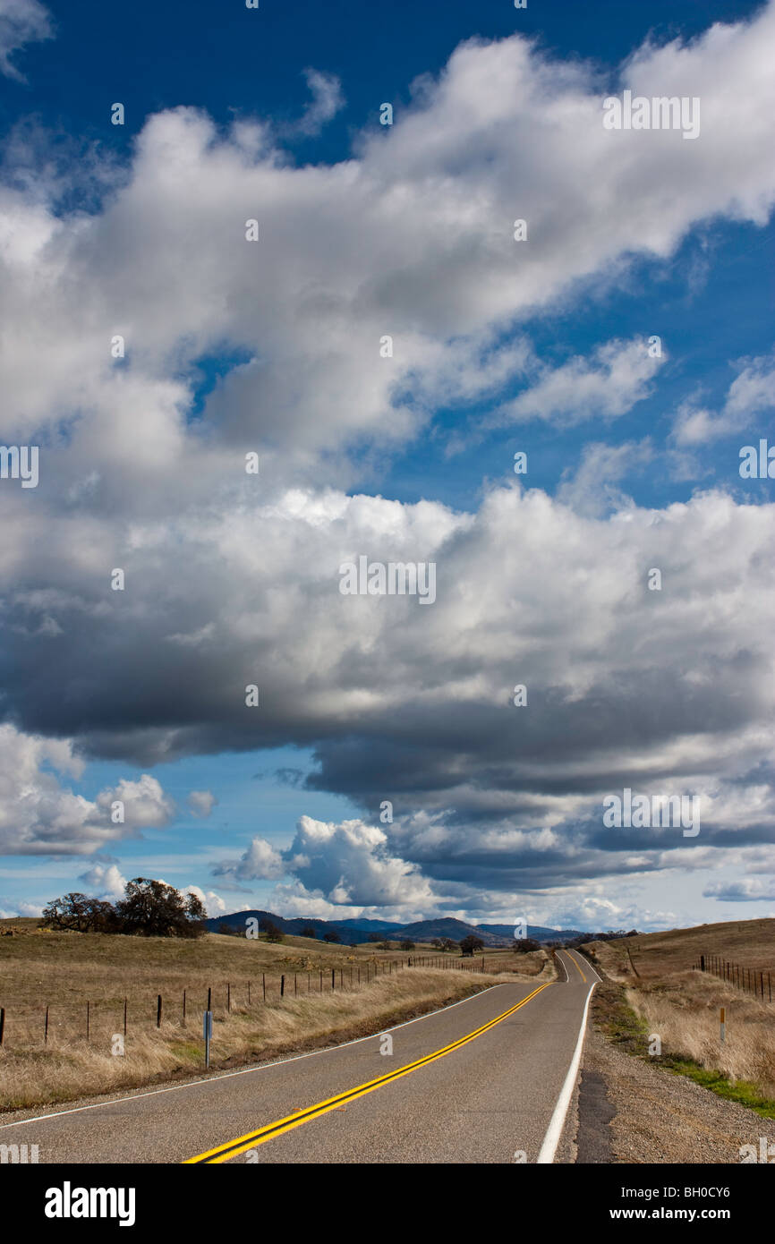 Highway 132 in California foothills with clearing rain clouds overhead ...
