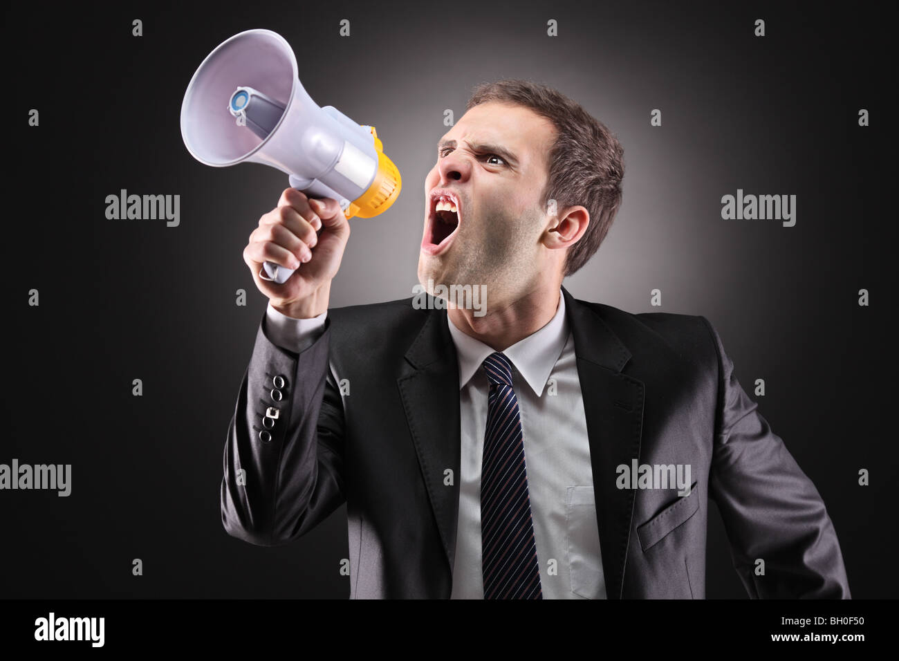 Businessman shouting on a megaphone Stock Photo - Alamy