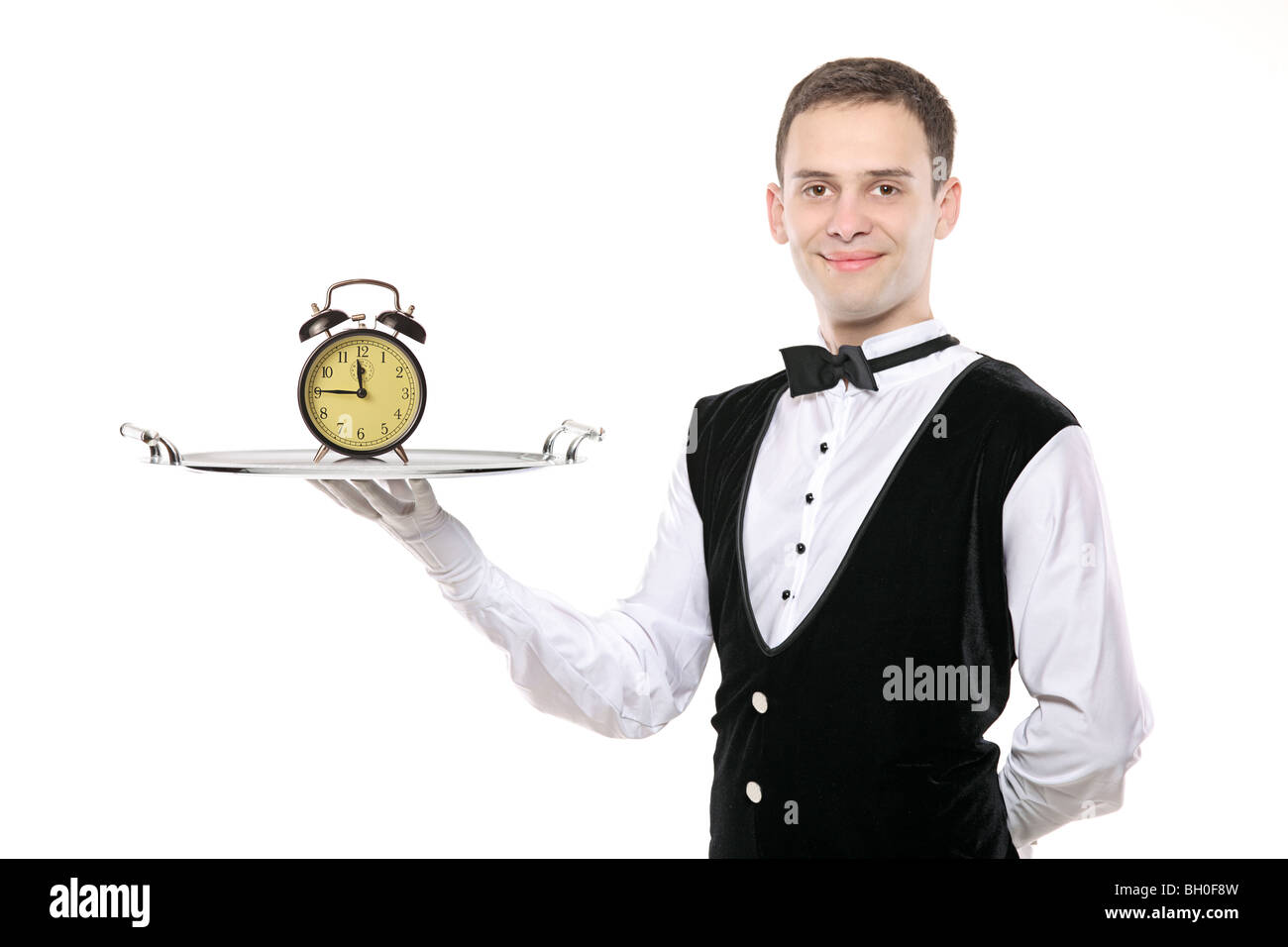 Butler holding a clock with a clock on it, isolated on white background ...