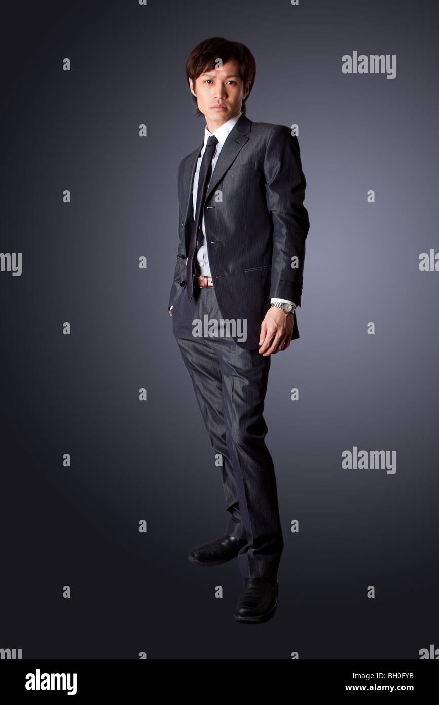 Successful Asian business man standing with confidence, isolated Stock ...