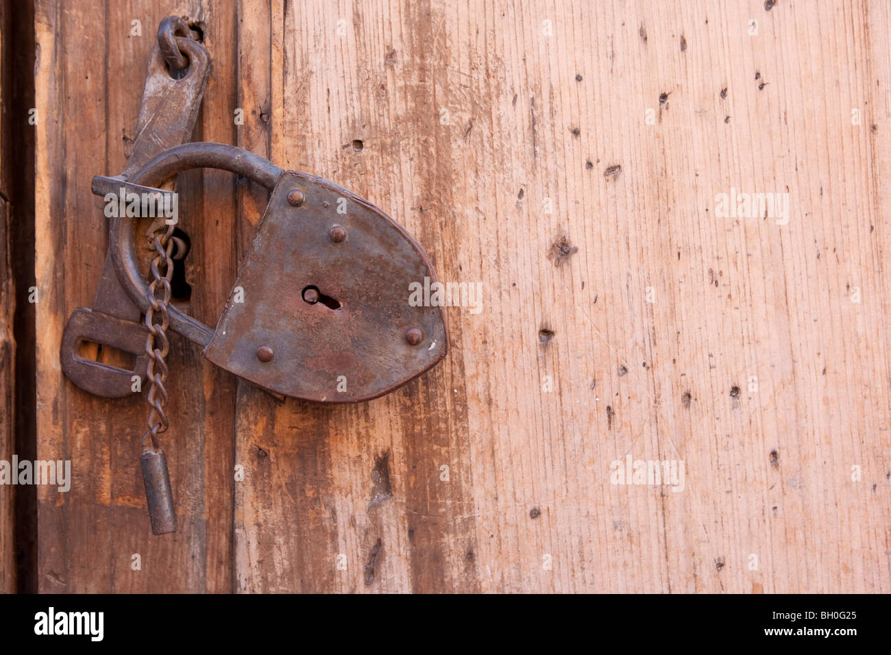 A rusty lock on a wooden gate Stock Photo - Alamy