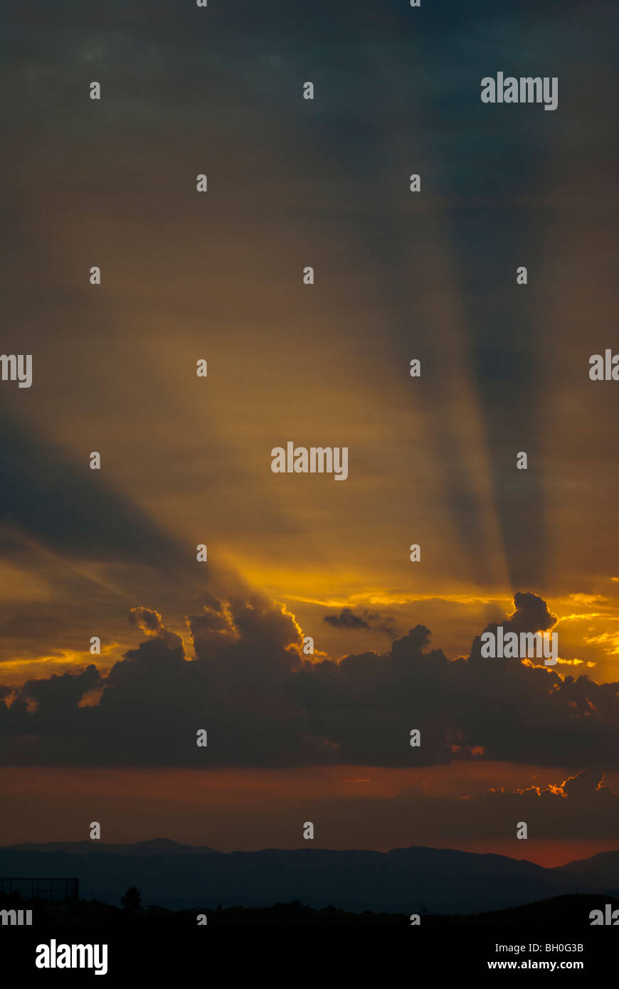 Sun rays breaking through a heavy clouded sky Stock Photo - Alamy