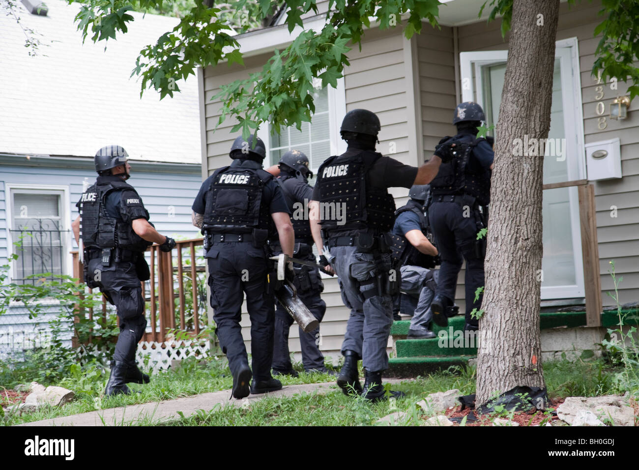 Police from tactical team making entry to serve a high-risk drug ...