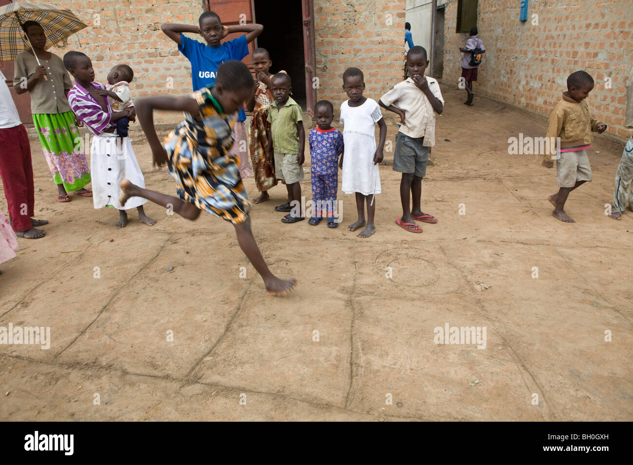 Orphaned children play hopscotch outside an orphanage in Amuria ...