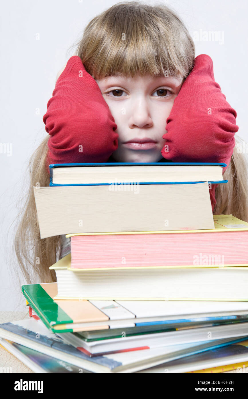 Is it possible to read all these books? little cute sad girl with a ...