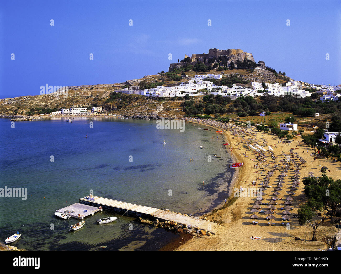 Lindos beach and castle ruins Rhodes Greece Stock Photo - Alamy