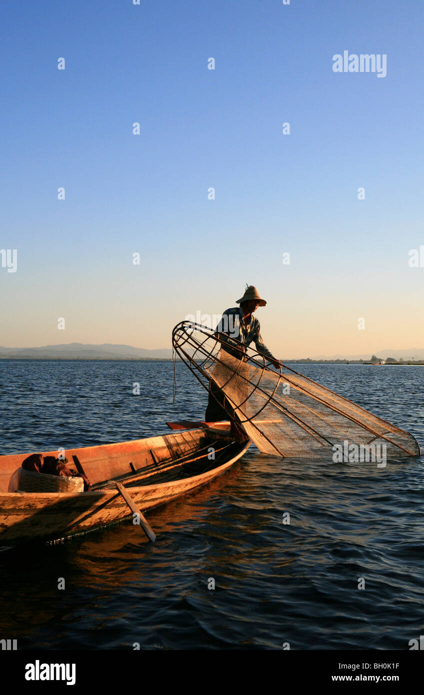 Intha fisherman with fish trap in the evening light, Inle Lake, Shan ...