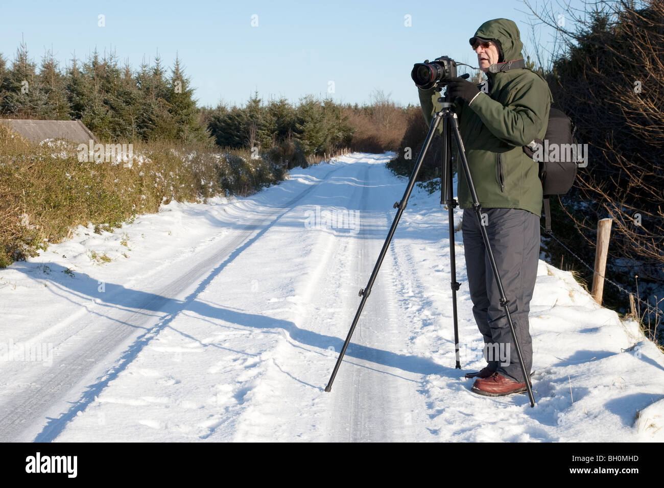 Photographer photographing snow scene, Ireland Stock Photo - Alamy