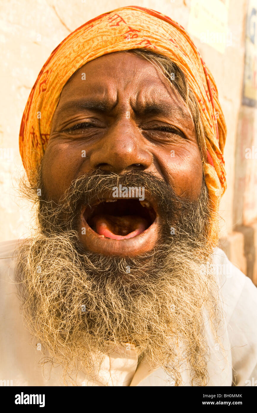 A bearded Indian man shows off his teeth in the ancient city of ...