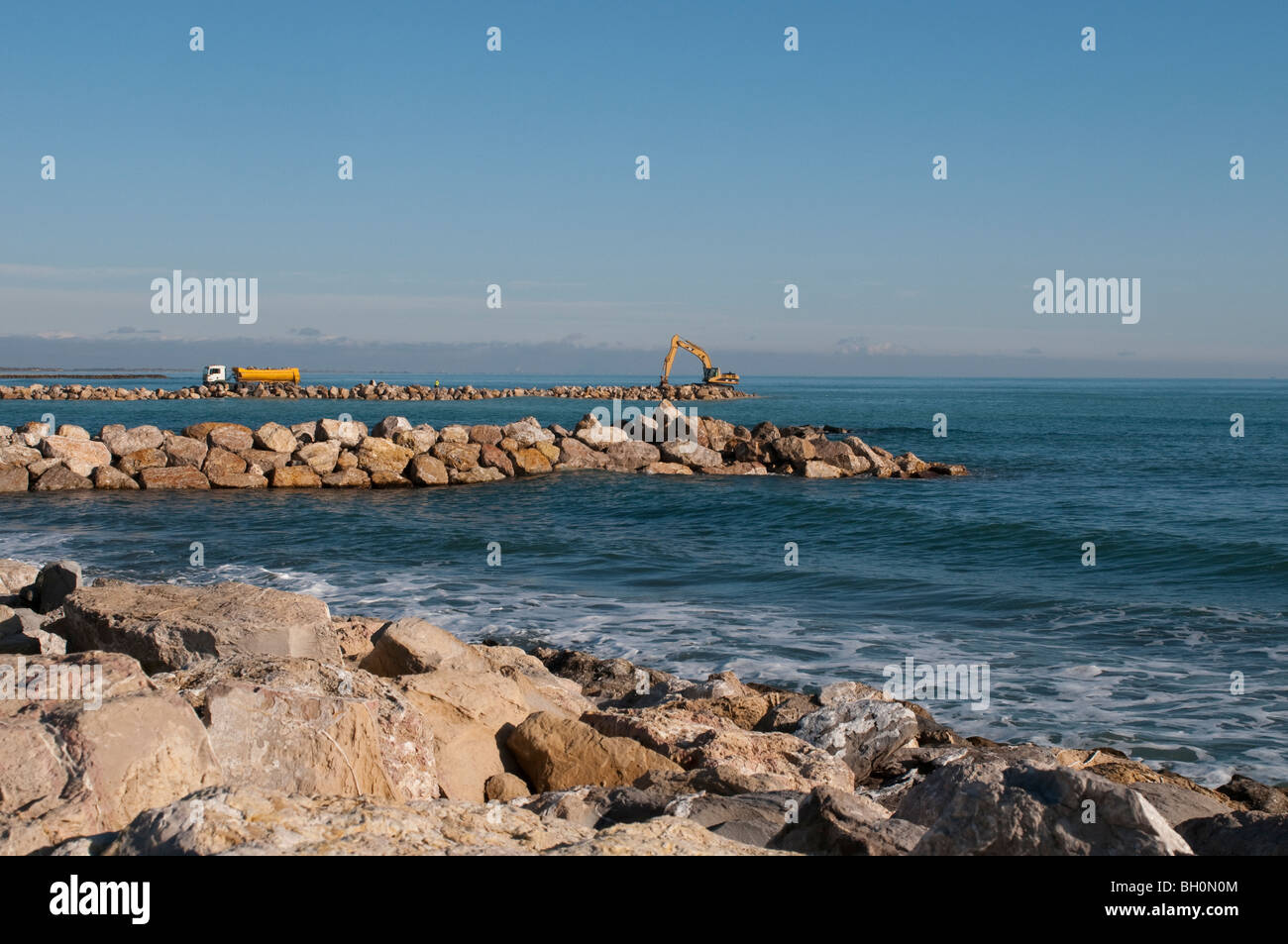 Construction of stone sea breakers, Saintes-Maries-de-la-Mer, Southern ...