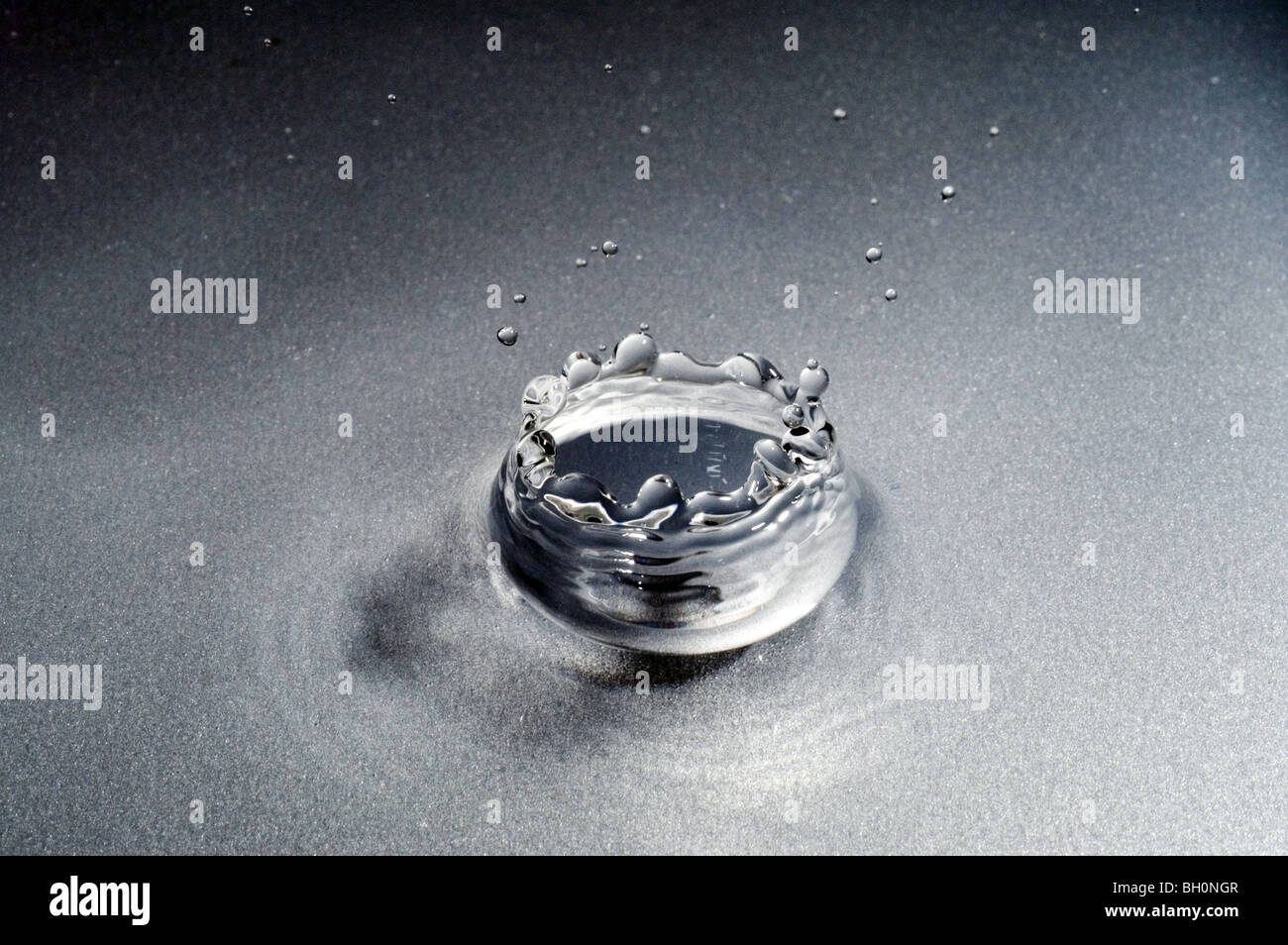 A drop of water splashing into a pool Stock Photo - Alamy