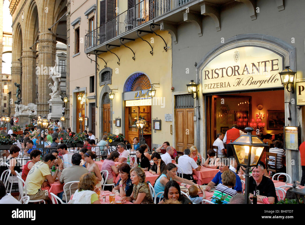 People at a restaurant in front of the Loggia, Piazza della Signoria ...