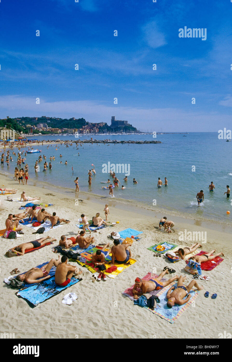 People sunbathing on the beach under blue sky, Golfo della Spezia ...