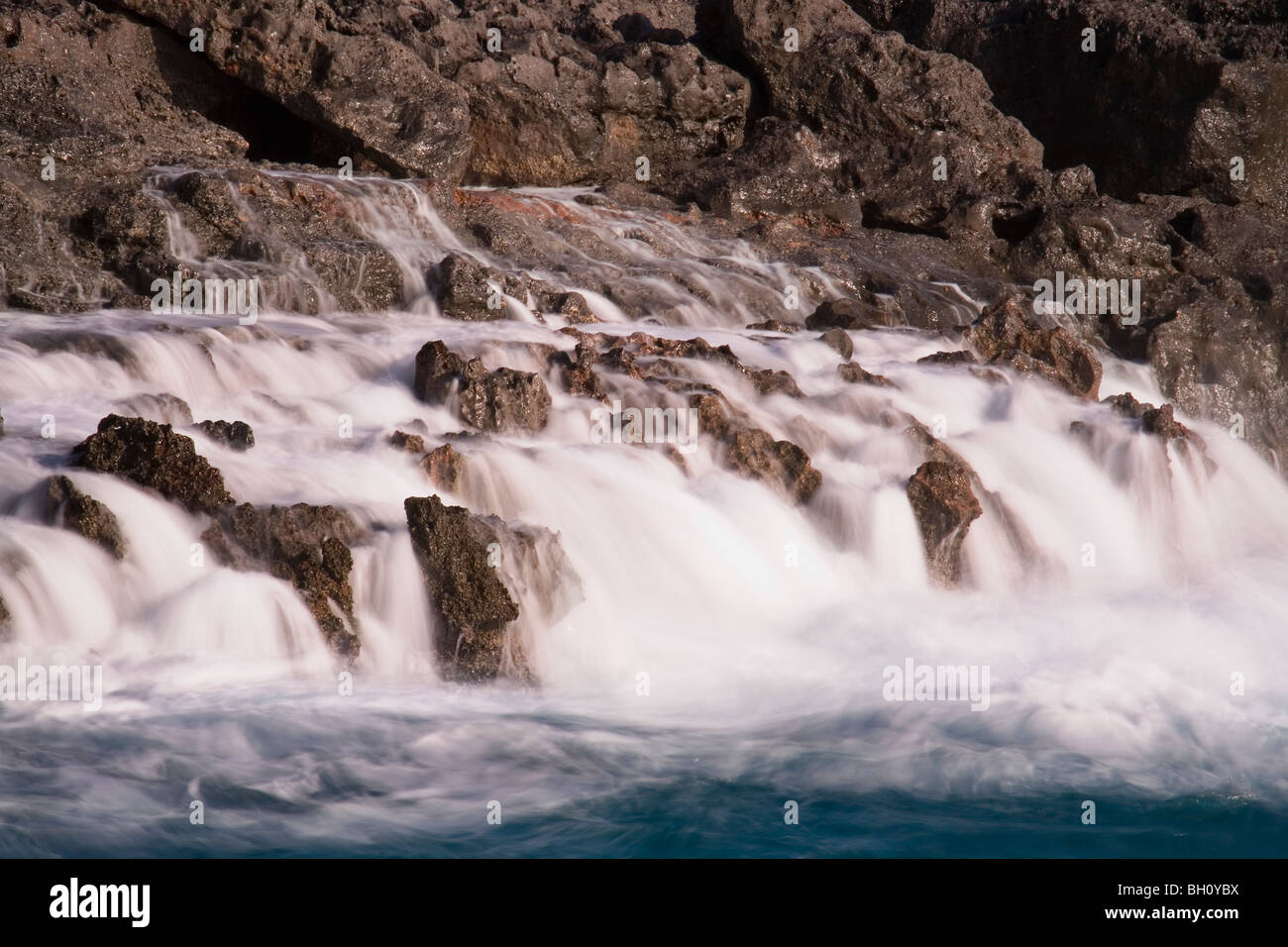 A wave retreating from rocky coastline in Greece Stock Photo - Alamy