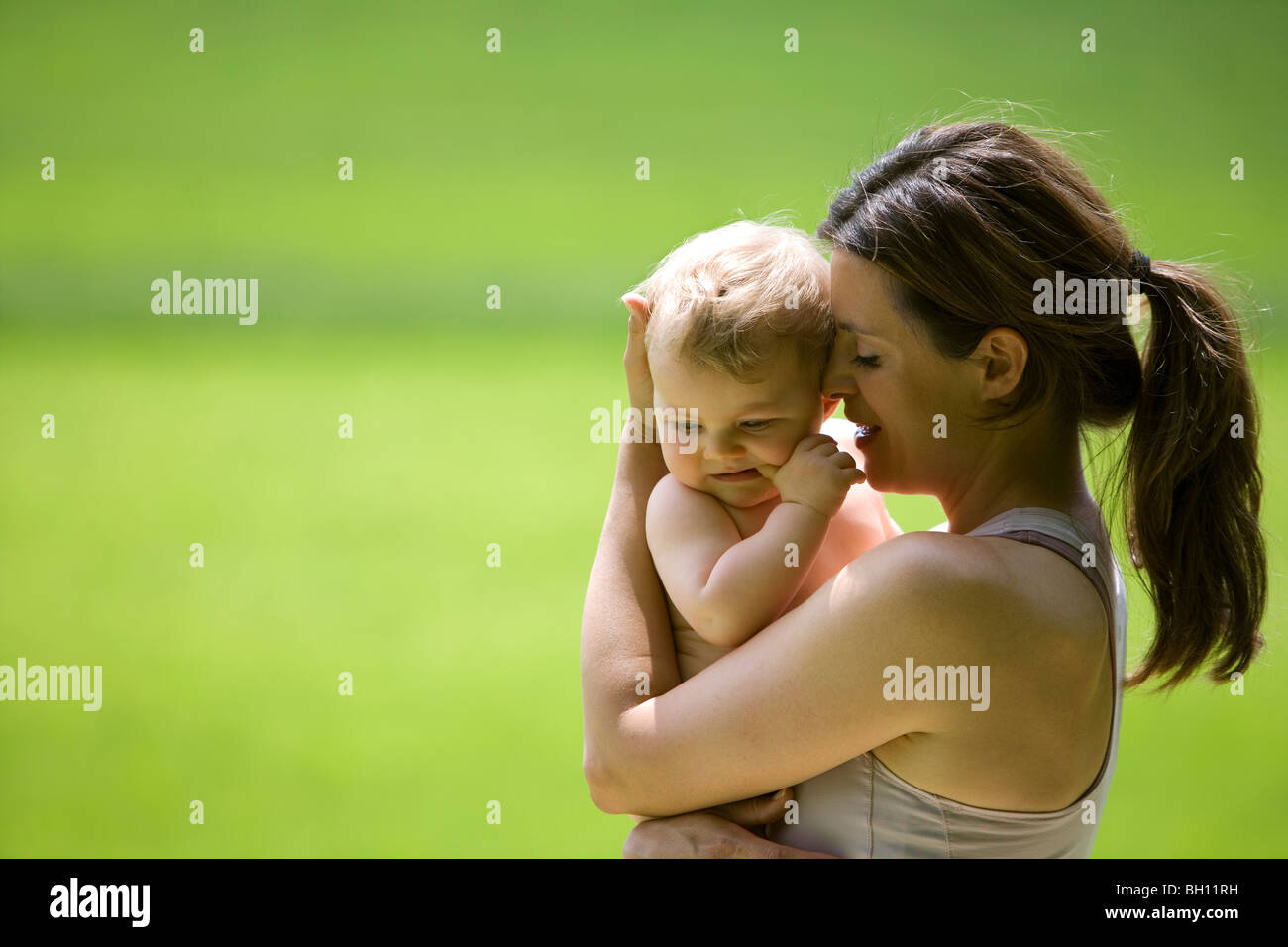 Mother embracing baby, 9 months Stock Photo - Alamy