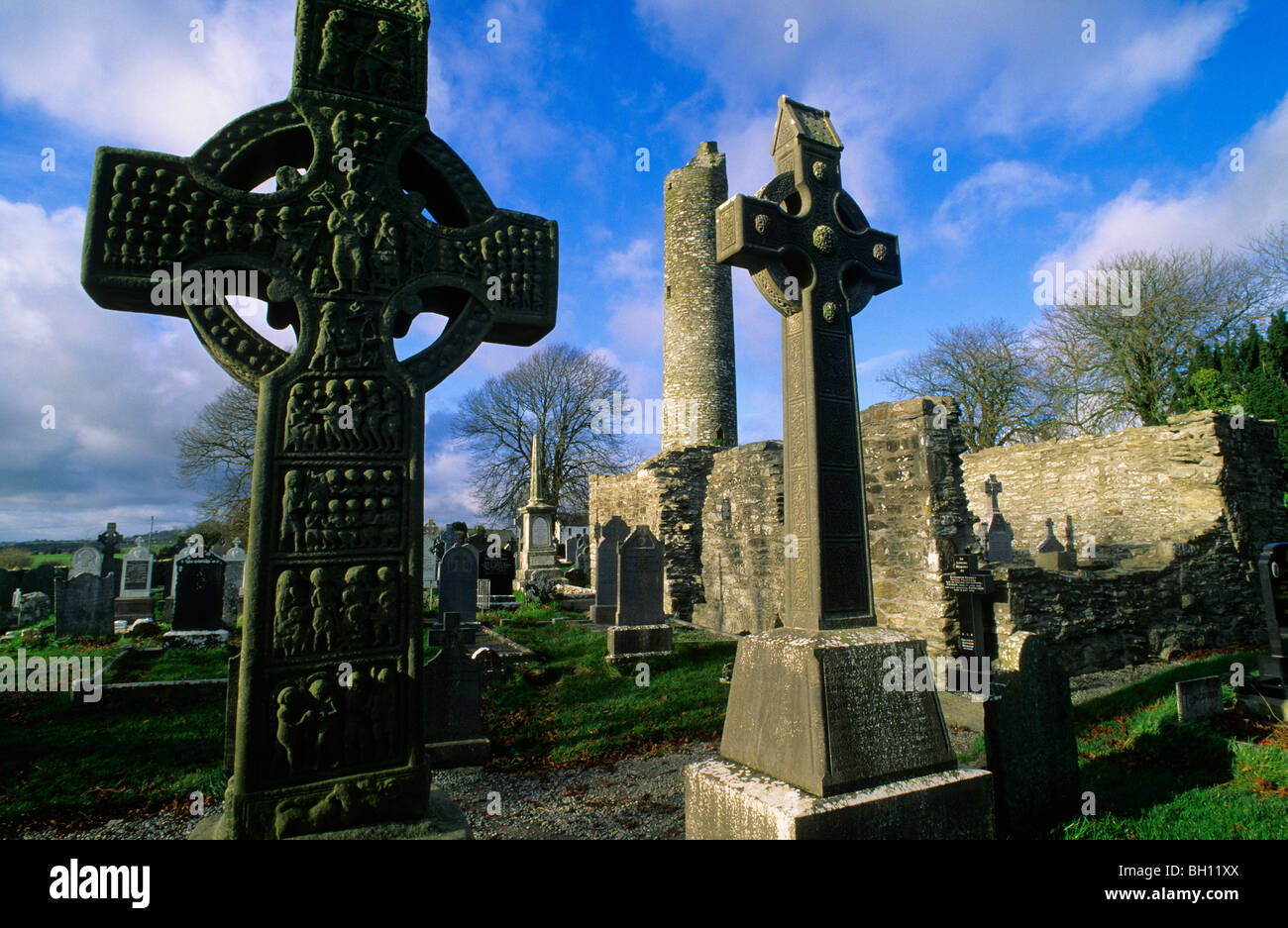 High crosses in front of the ruins of Monasterboice abbey under clouded ...