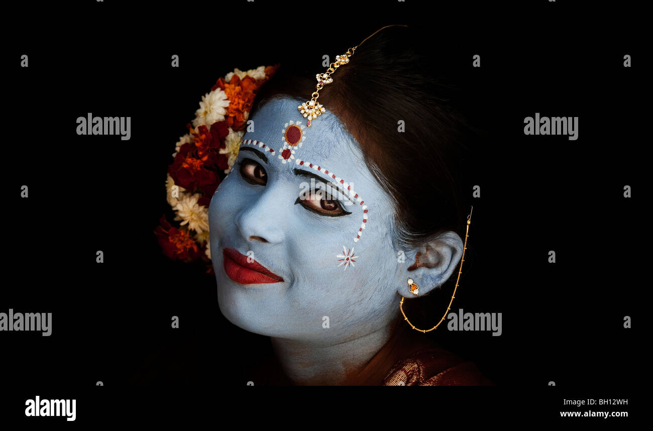 Indian girl face painted as the Hindu goddess Sita against a black ...