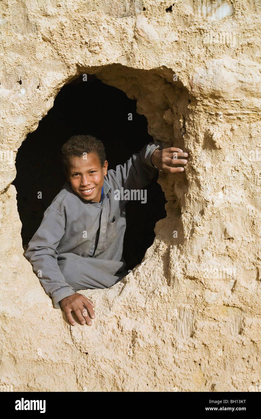 A smiling Berber boy looking out from the Fortress of Shali in Siwa ...