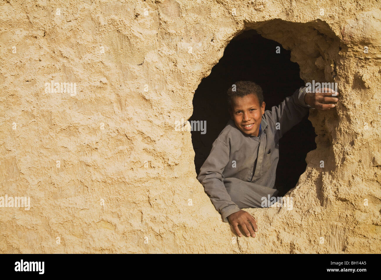 A smiling Berber boy looking out from the Fortress of Shali in Siwa ...