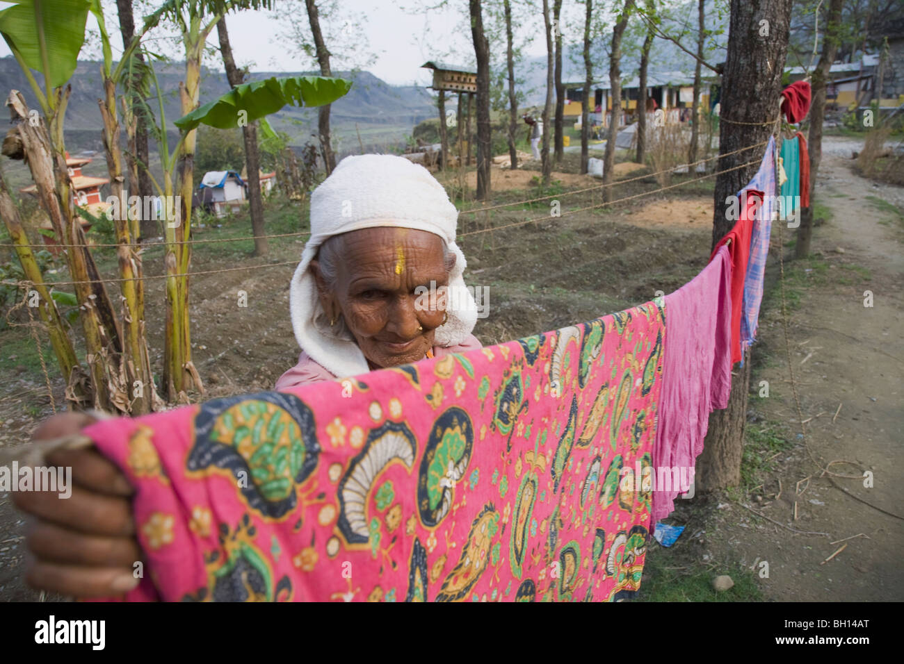 Elderly woman hanging clothes, Pokhara, Chitwan, Nepal Stock Photo - Alamy