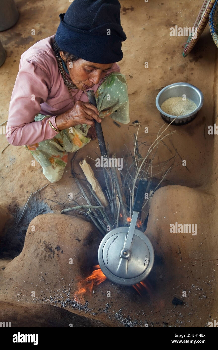 Woman stoking wood fire by mouth, Pokhara, Nepal Stock Photo - Alamy