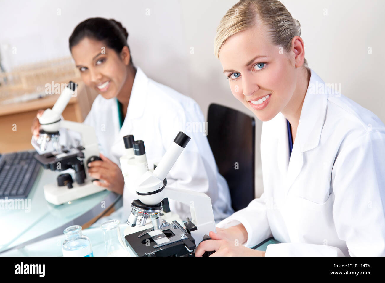 A blond female medical or scientific researcher or doctor using her ...