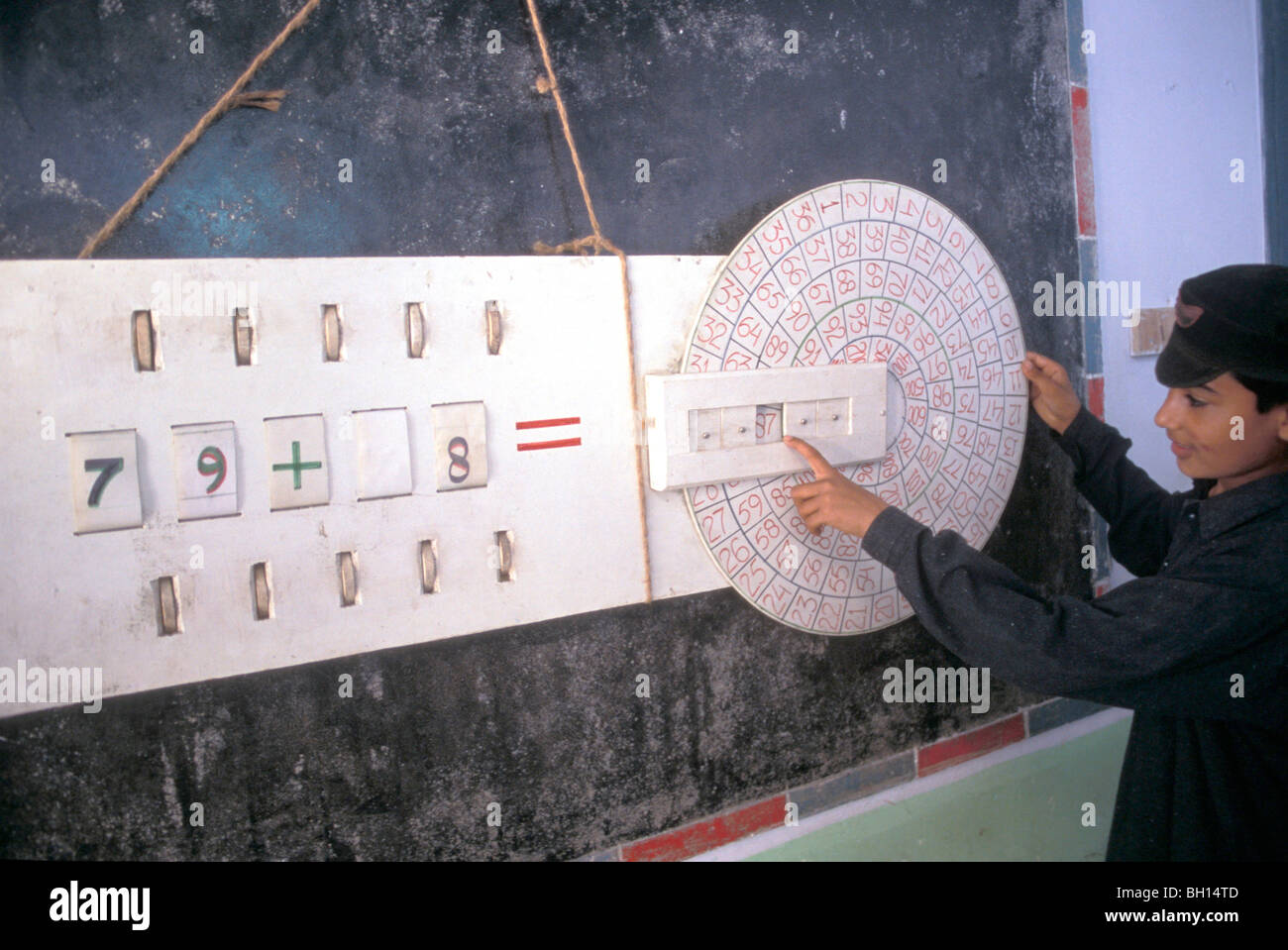 PAKISTAN.CHILD LEARNING MATHS IN TRADITIONAL WAY AT CLASSROOM IN A ...