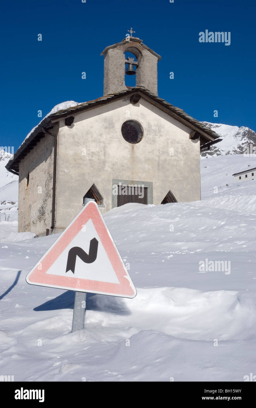 curves road sign and small church near Passo dello Spluga / Splugen ...